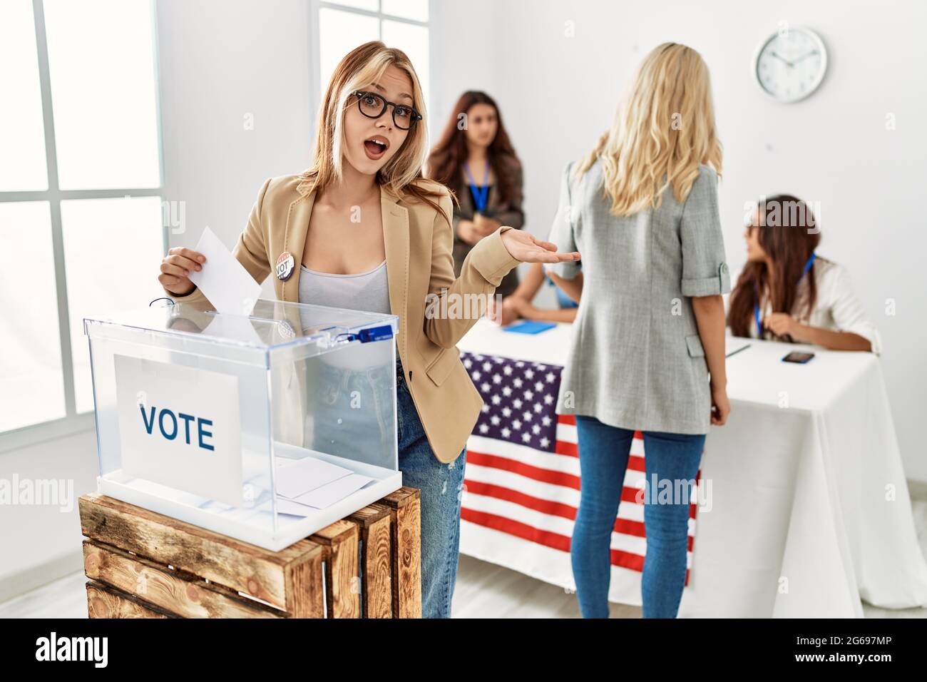 Group of young girls voting at democracy referendum pointing aside with ...