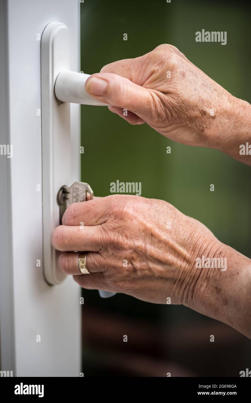 Older hands locking door hi-res stock photography and images - Alamy
