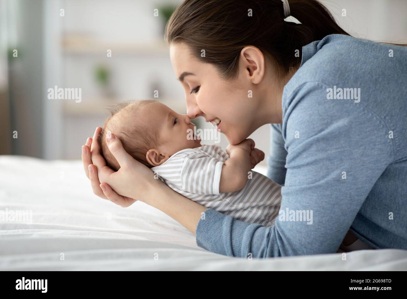 Physical Contact With Infant. Happy Mom Touching Noses With Her Newborn ...