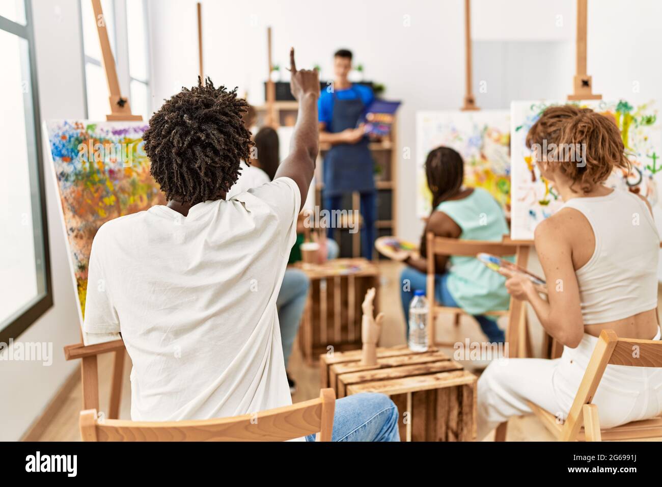 Group of people smiling happy drawing in paint class at art studio ...
