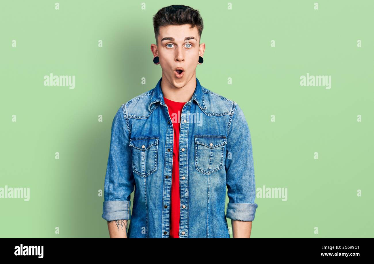 Young caucasian boy with ears dilation wearing casual denim jacket ...