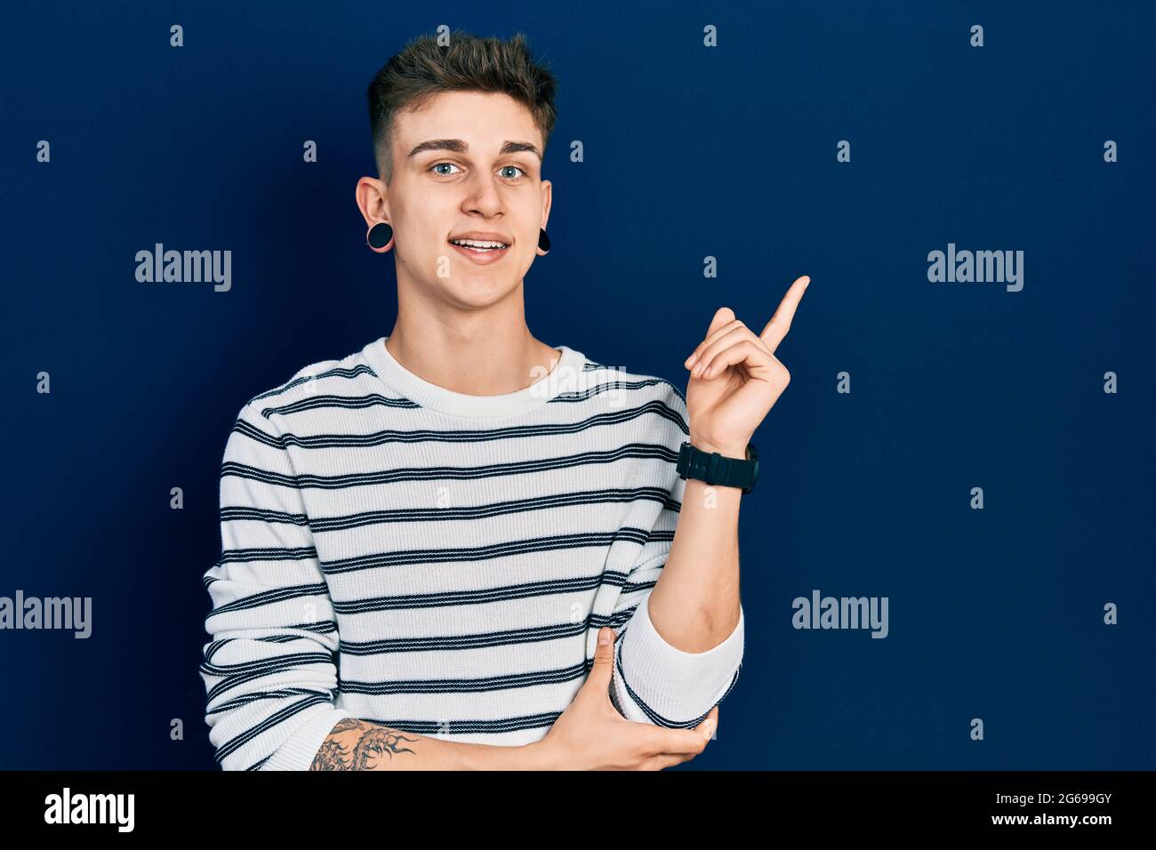 Young caucasian boy with ears dilation wearing casual striped shirt ...