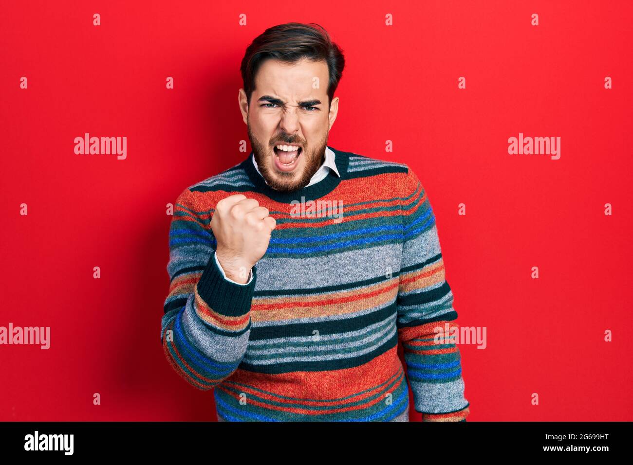Handsome caucasian man with beard wearing elegant wool winter sweater ...