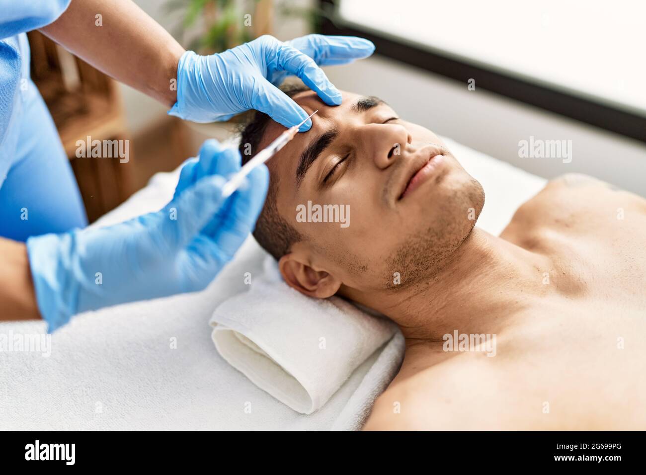 Doctor injecting botox on man face for anti aging treatment at the ...