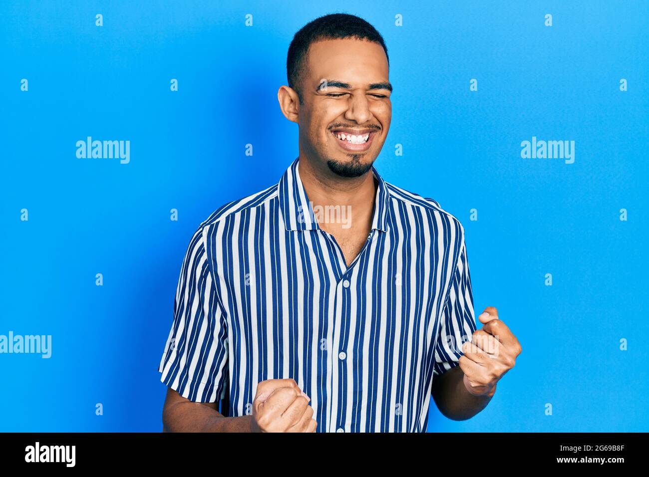Young african american man wearing casual clothes excited for success ...