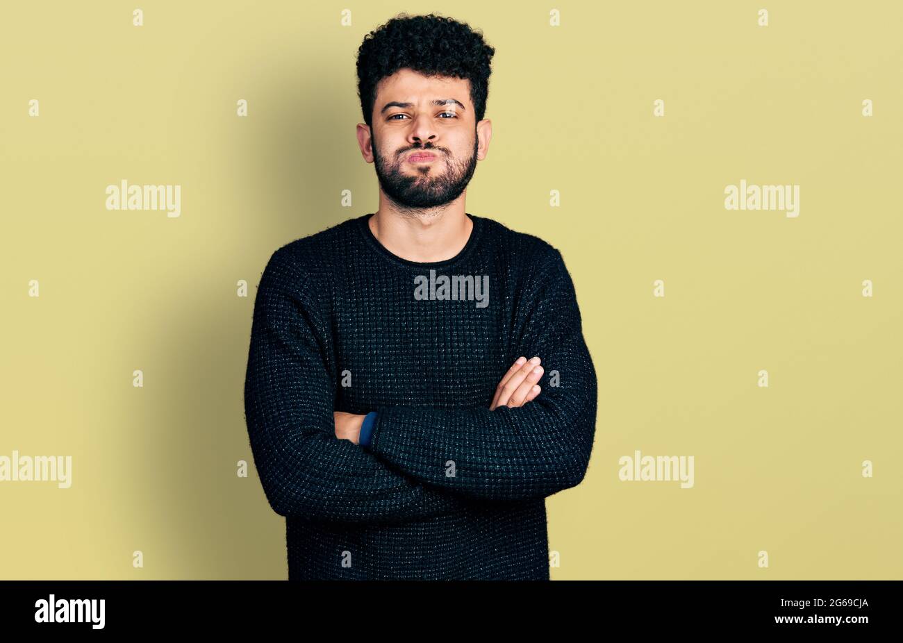 Young arab man with beard with arms crossed gesture puffing cheeks with ...