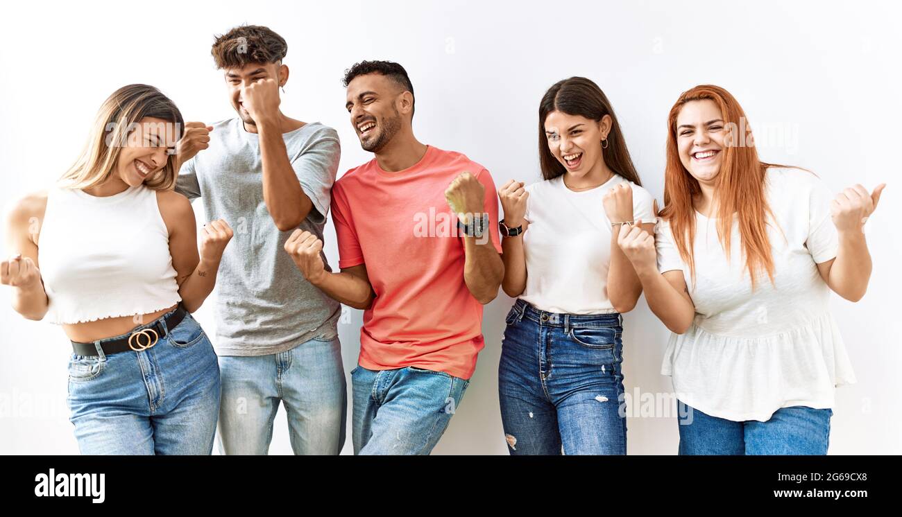 Group of young friends standing together over isolated background very ...