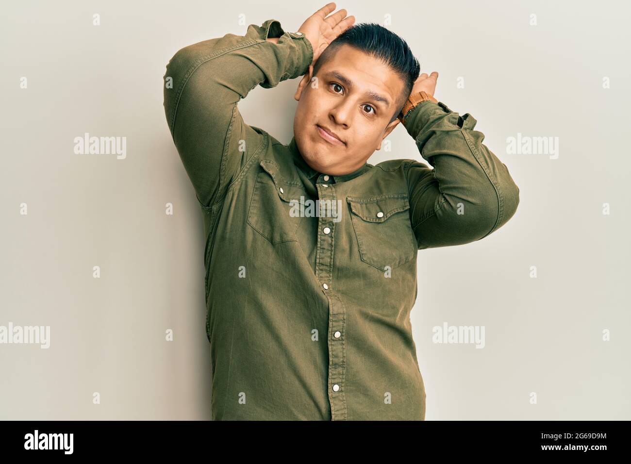 Young latin man wearing casual clothes doing bunny ears gesture with ...
