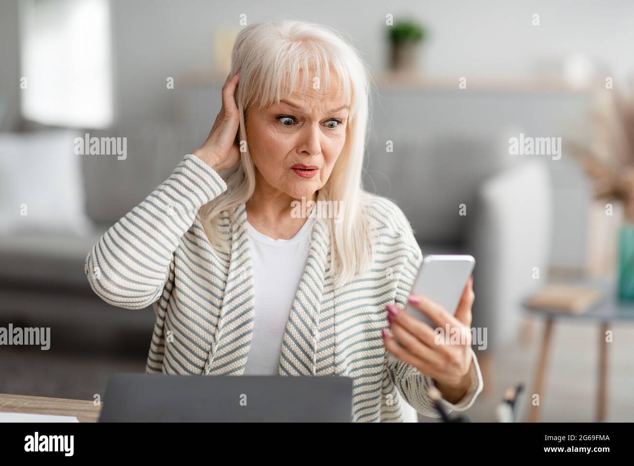 Shocked mature woman using hi-res stock photography and images - Alamy