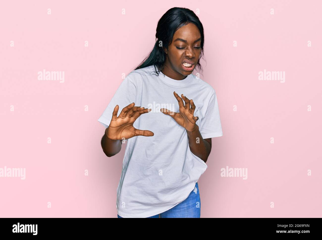 Young african american woman wearing casual white t shirt disgusted ...