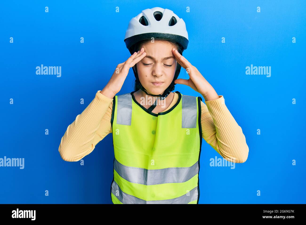 Beautiful brunette little girl wearing bike helmet and reflective vest ...