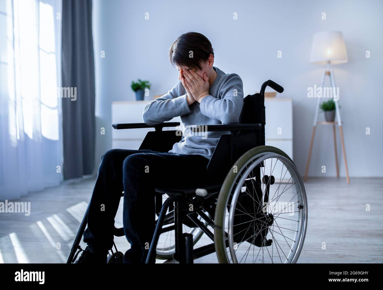 Teen depression and disability. Unhappy handicapped teenager in ...