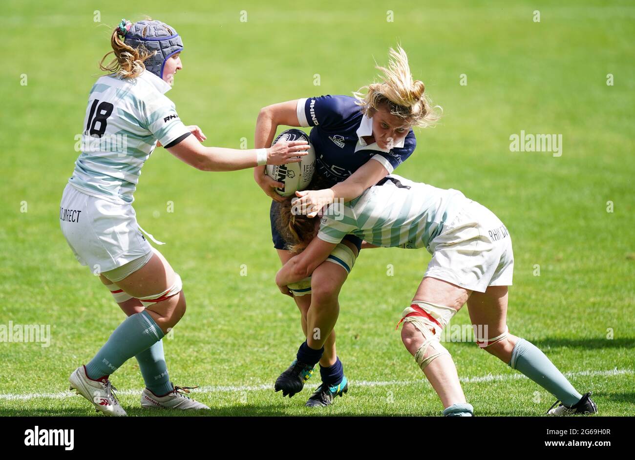 Oxford's Alex Travers (centre) in action with Cambridge's Alice Elgar ...