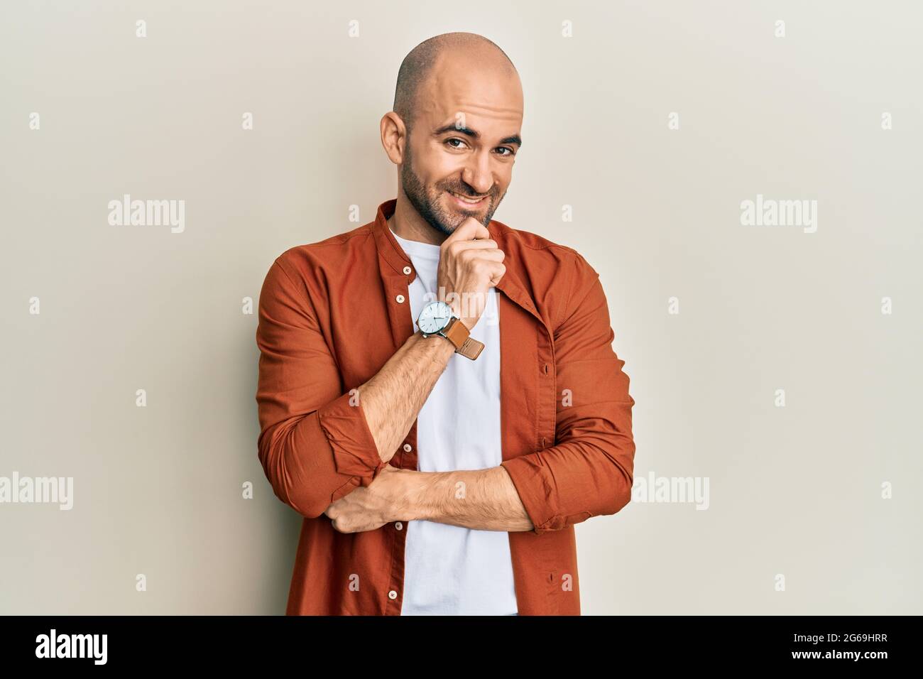 Young hispanic man wearing casual clothes smiling looking confident at ...