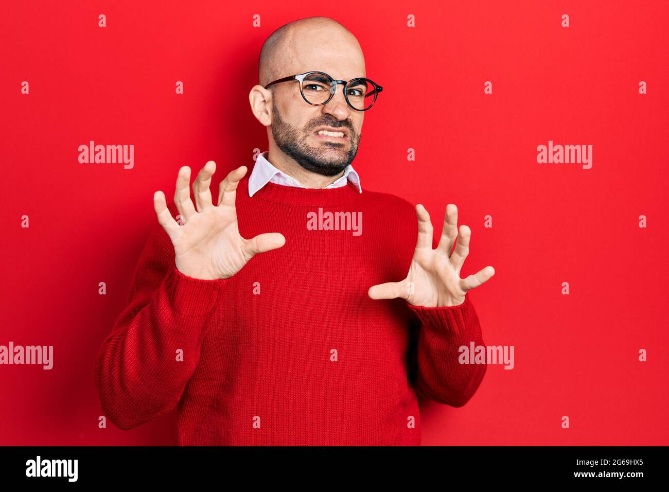 Young bald man wearing casual clothes and glasses afraid and terrified ...