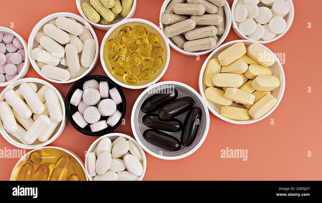 close-up of multivitamin biologically active supplements on coral ...