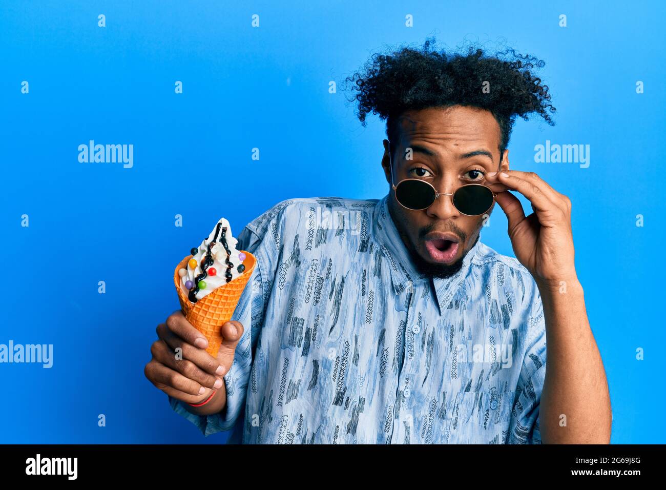 Young african american man with beard wearing summer style holding ice ...
