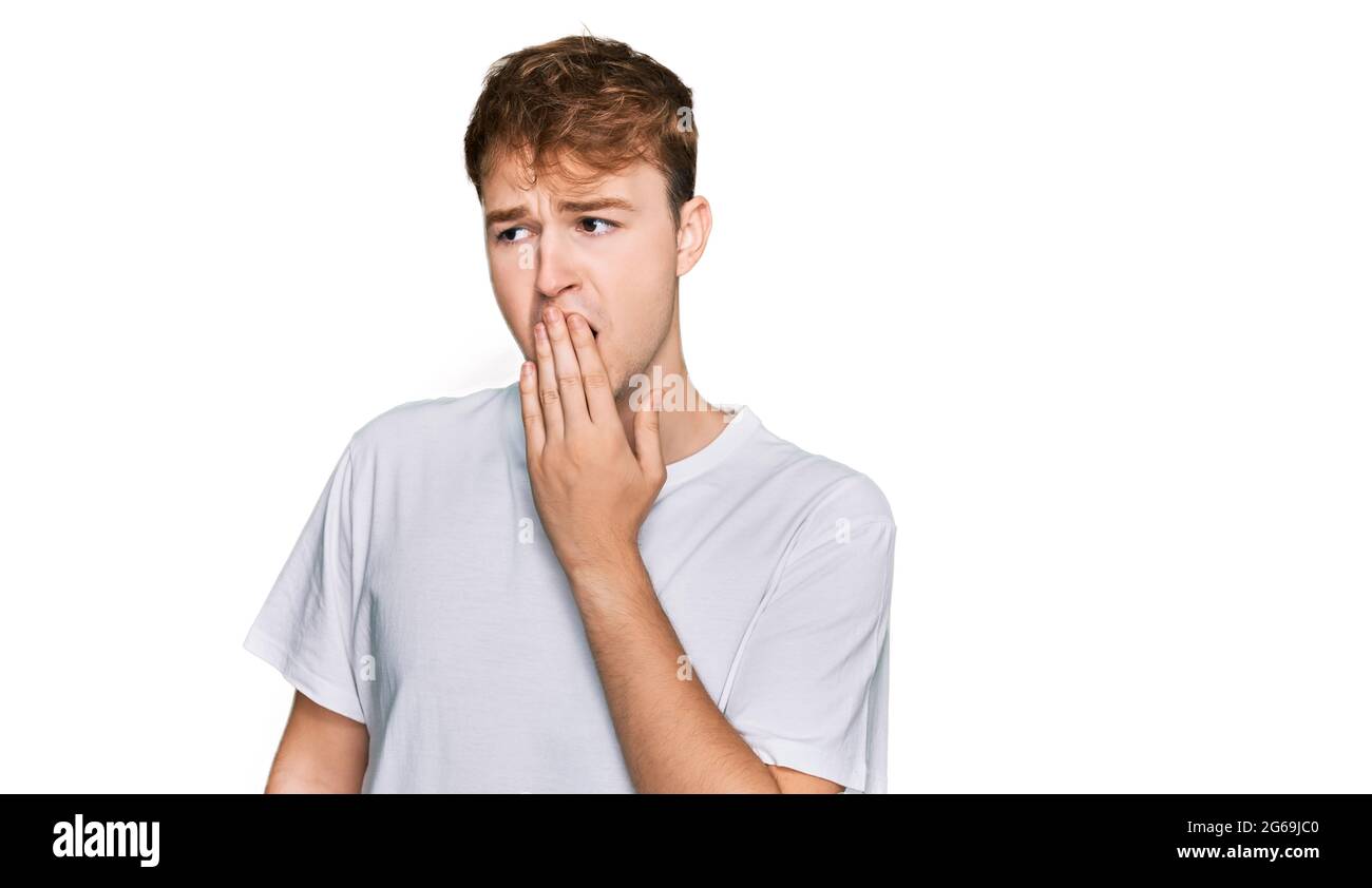Young caucasian man wearing casual white t shirt bored yawning tired ...