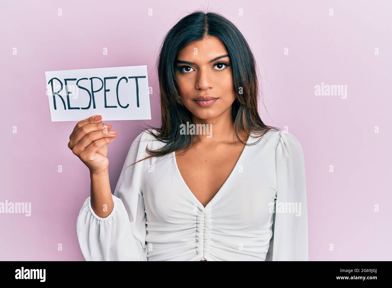 Young latin transsexual transgender woman holding respect message paper ...