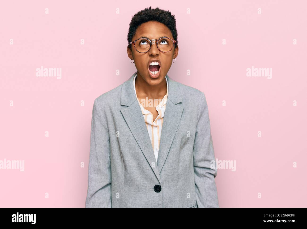 Young african american woman wearing business clothes angry and mad ...