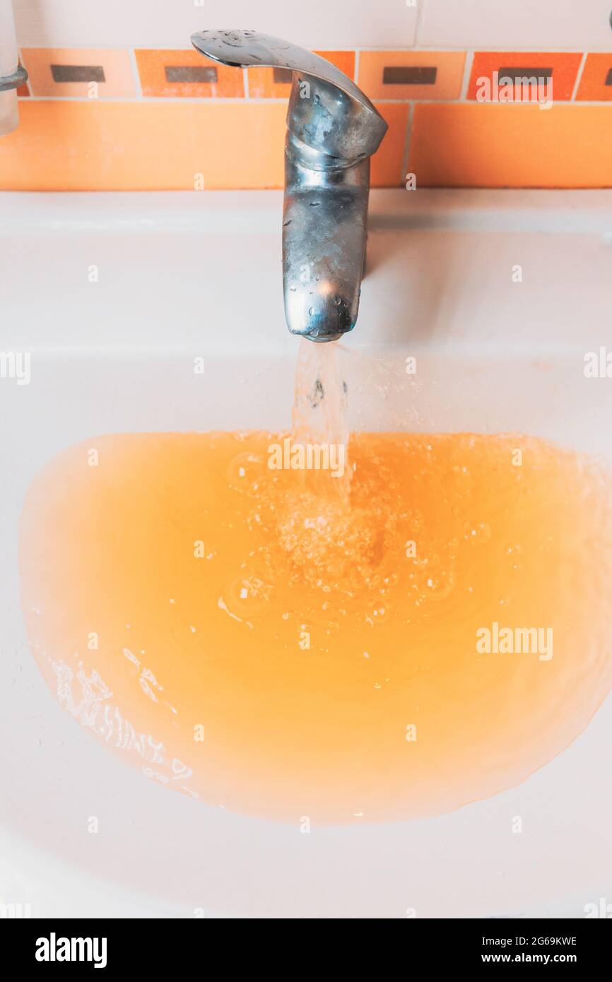 Rusty Water Pours From Tap. Water Pollution. Global Environment Stock ...