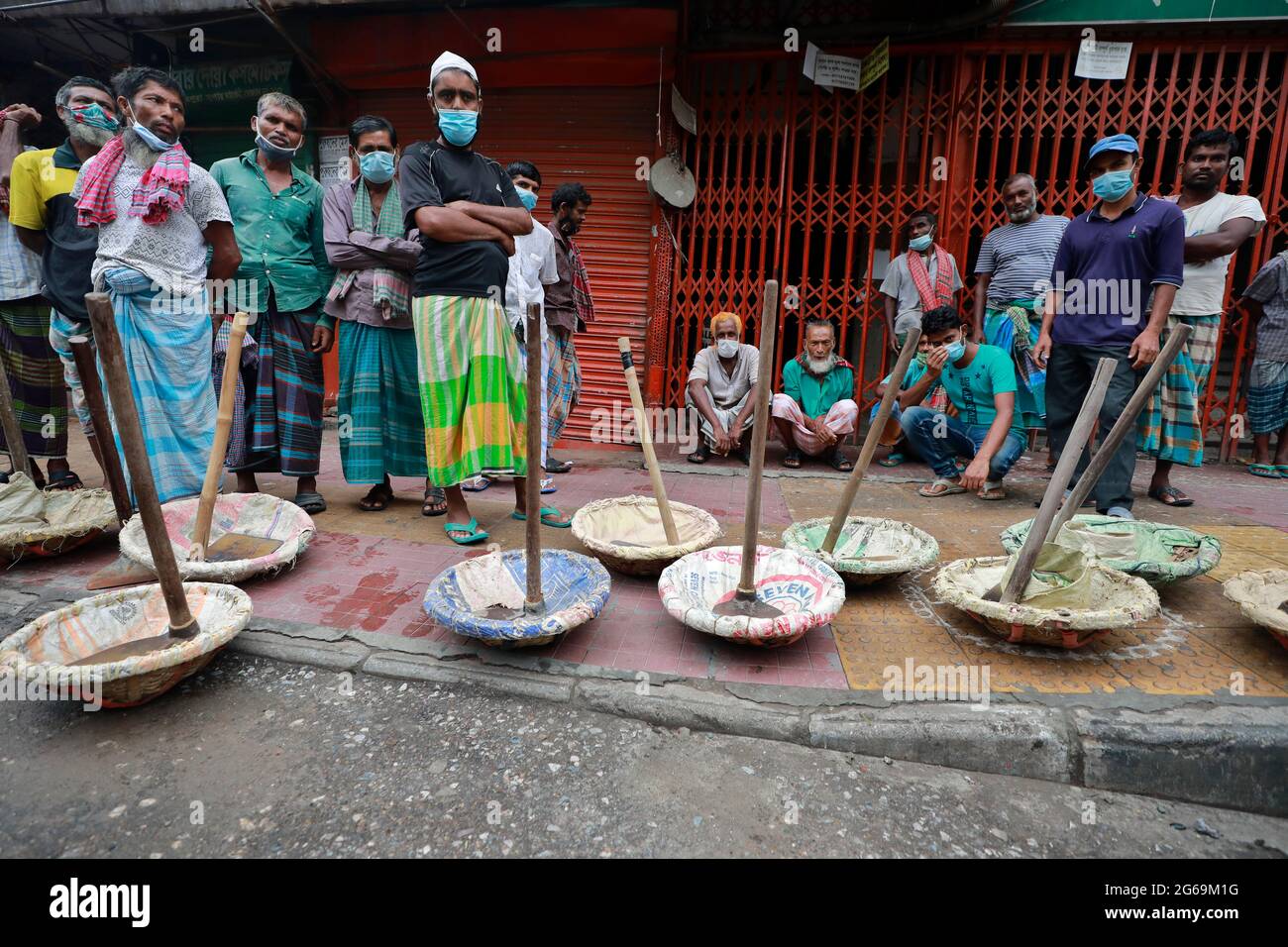 Dhaka, Bangladesh - July 03, 2021: Day laborers are sitting on the ...