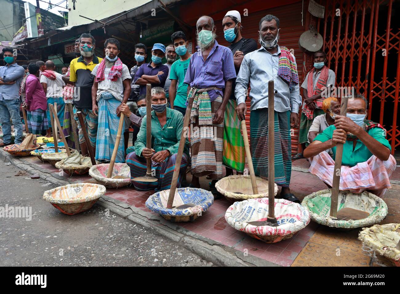 Dhaka, Bangladesh - July 03, 2021: Day laborers are sitting on the ...