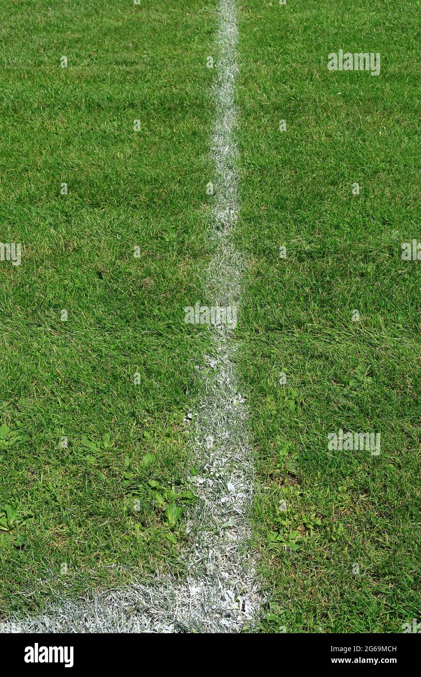 A Straight white line on a green field Stock Photo - Alamy