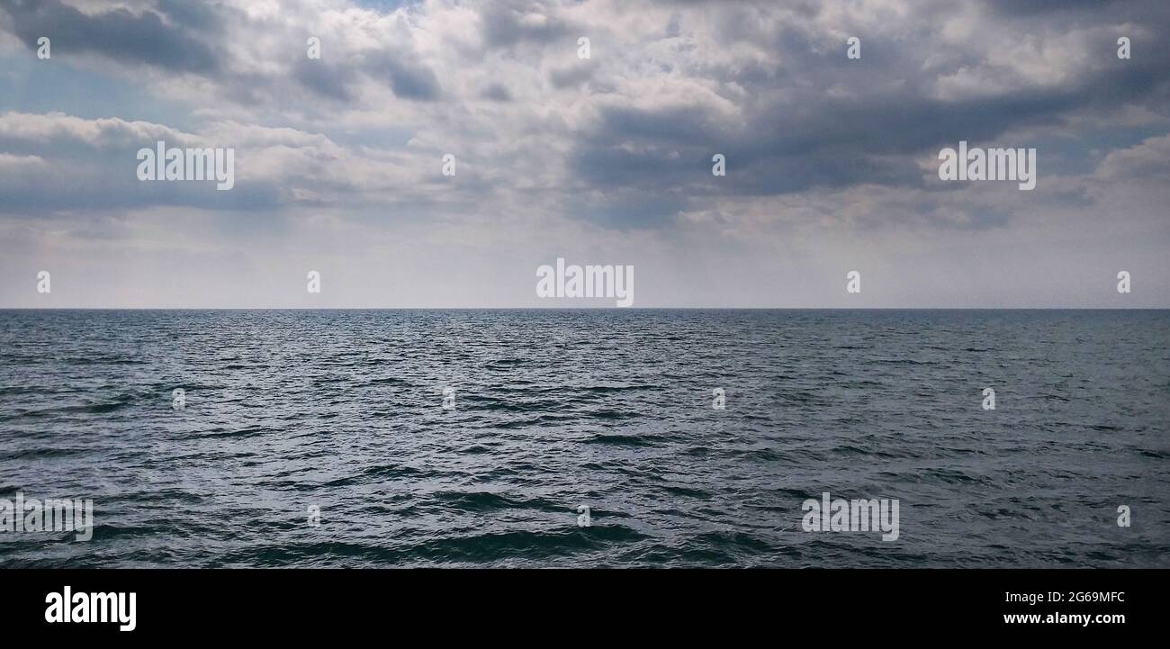 horizontal background: calm sea and sky with clouds Stock Photo - Alamy