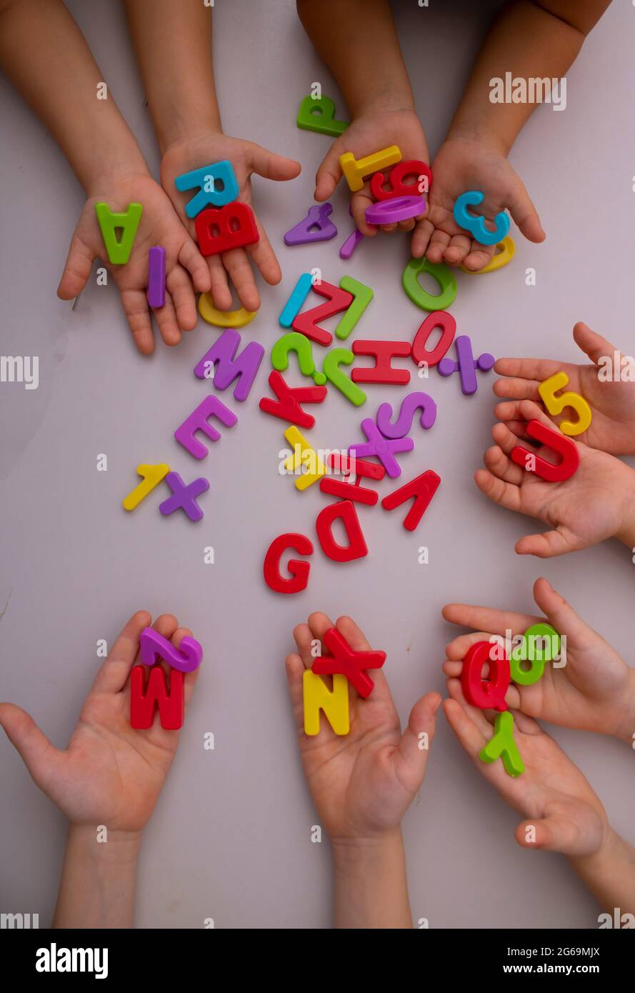 Children learning the alphabet, vertical photo. Top view Stock Photo ...