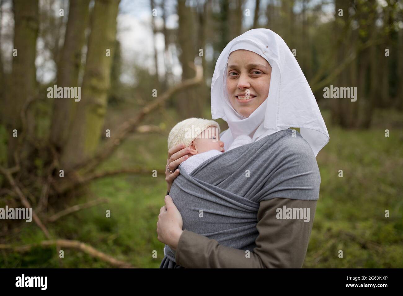 Interpretation of mother holding her baby in a sling wrap in early ...