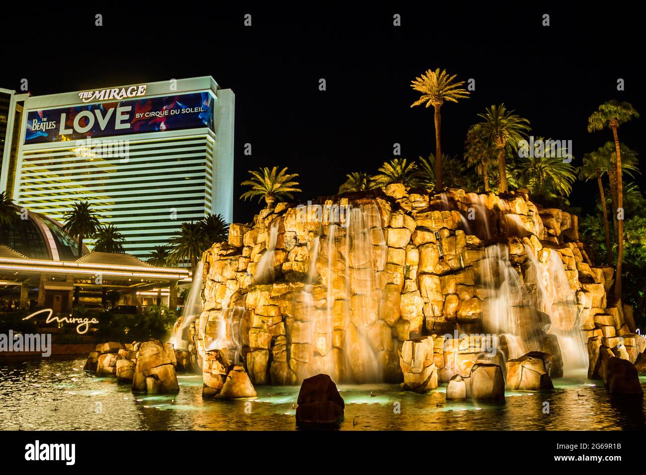 The pool with palm trees by the Mirage at night Stock Photo - Alamy