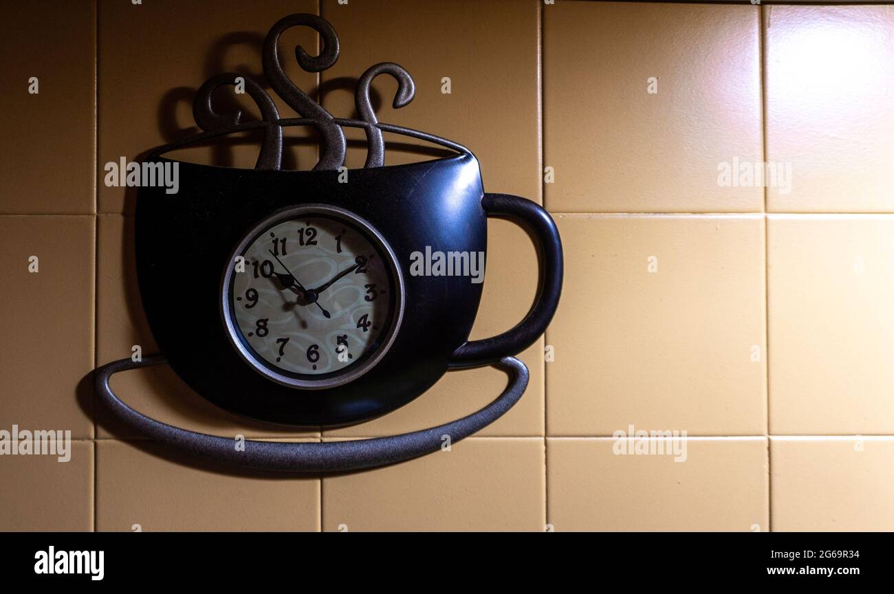 wall clock in the shape of a steaming coffee cup Stock Photo - Alamy