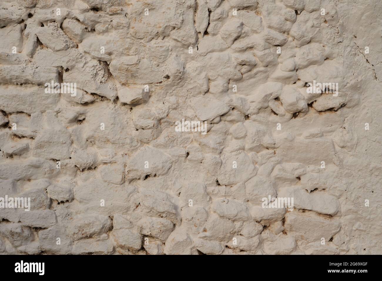 Old traditional limewashed stone wall, white rustic background or ...