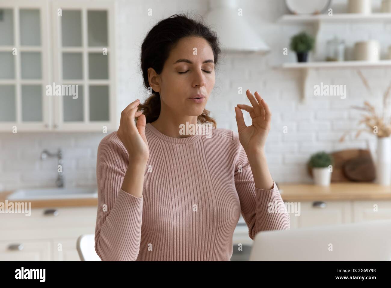 Mindful young woman calming down in stressful situation Stock Photo - Alamy