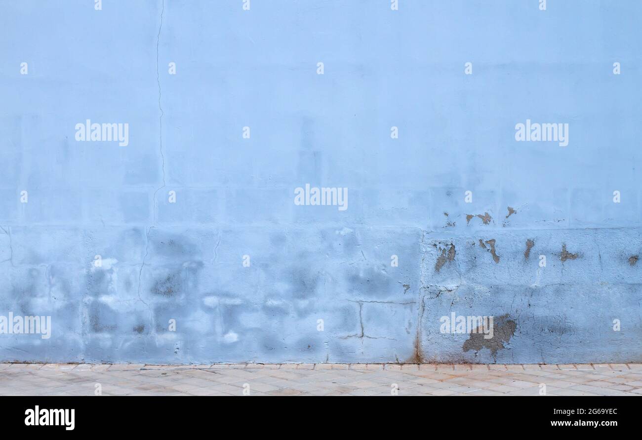 Blue plastered wall with damp and peeling paint, urban grungy ...