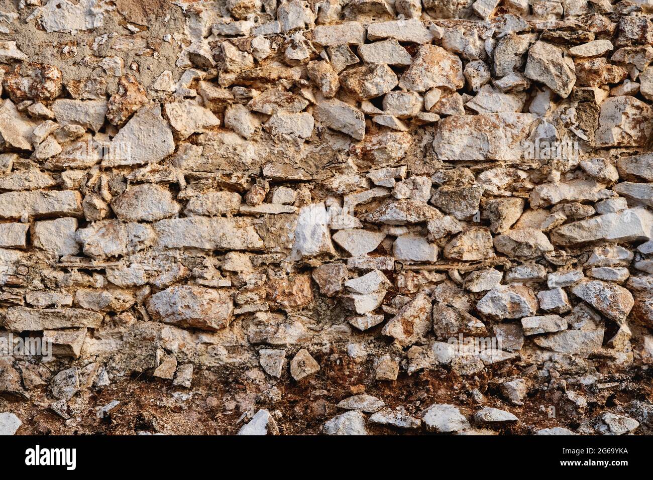 Old traditional limewashed stone wall with peeling plaster, rustic ...