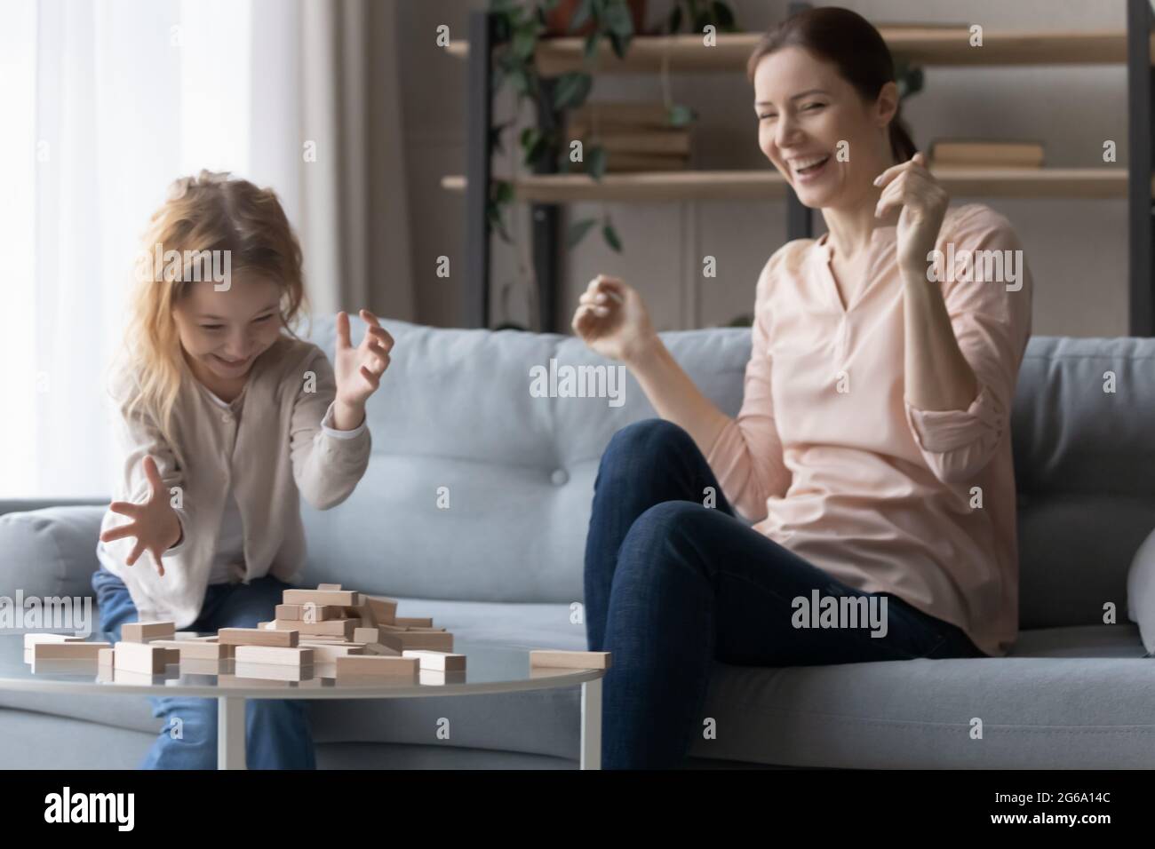 Foster mother having fun play board game with adopted daughter Stock ...