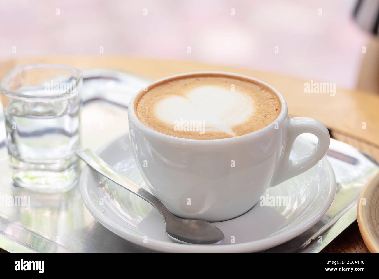 Espresso coffee in white cup on the tray with a glass of water Stock ...