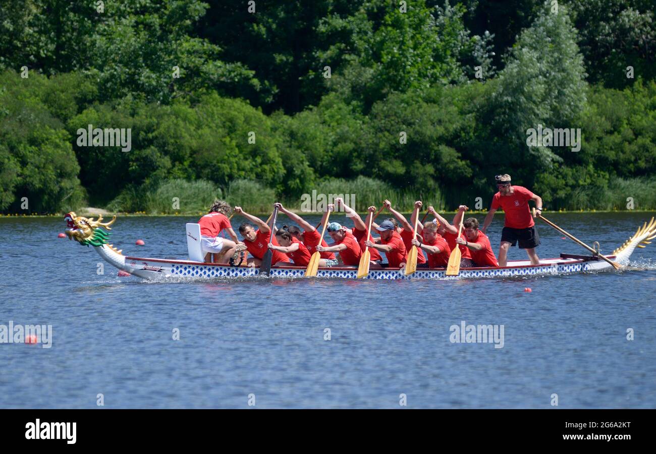 Oarsmen rowing a dragon boat on a river. Kiev oblast championship among ...