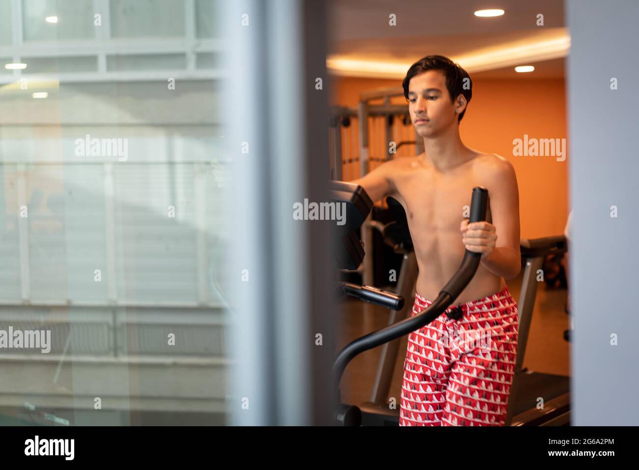 Teenage boy work out on treadmill in gym Stock Photo - Alamy