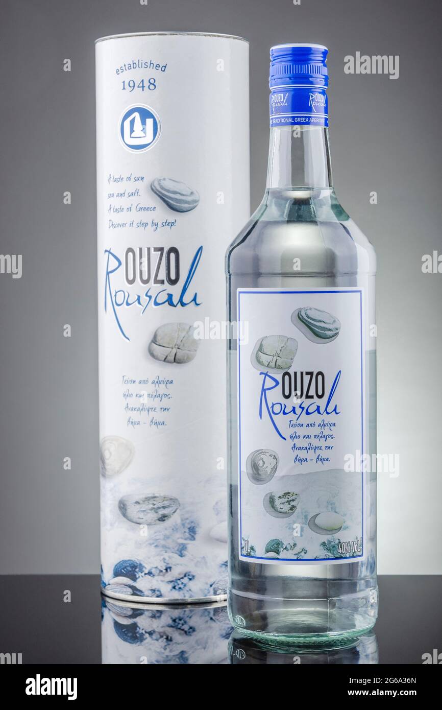 Bottle of Rousali ouzo isolated on gradient background. Ouzo is dry ...