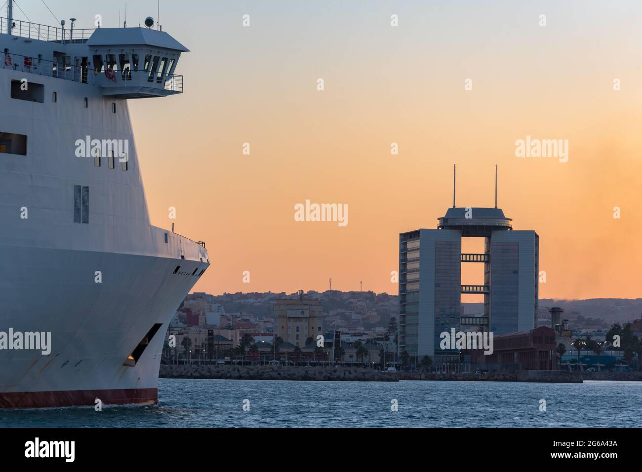 Passenger ship or ferry entering the port of Melilla at sunset Stock ...