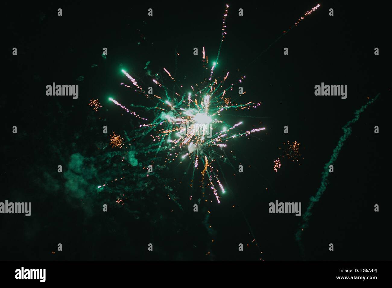 A closeup shot of fireworks on a night sky background Stock Photo - Alamy