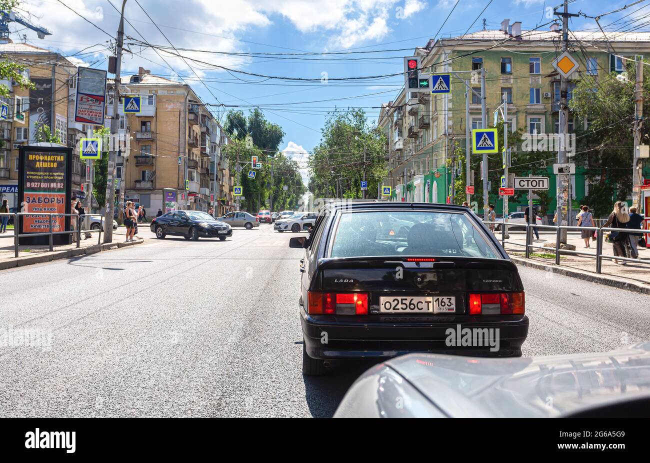 Samara, Russia - July 2, 2021: Cars drive along city street with multi ...