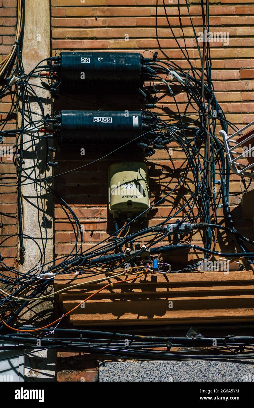 Seville Spain July 03, 2021 Electric cables on the facade of a building ...