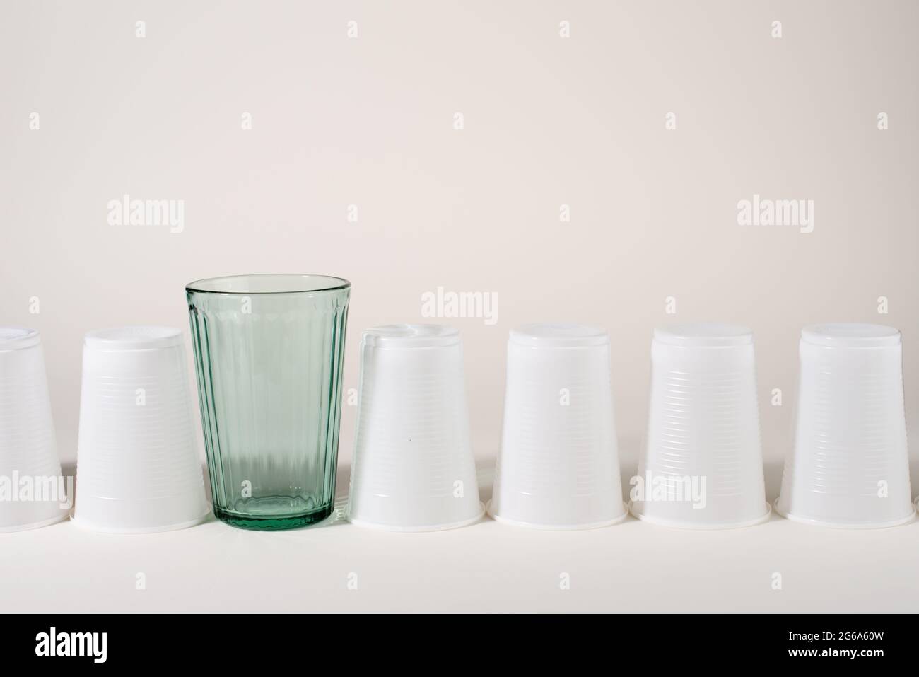 Glass and many plastic cups in a raw. Glass or plastic. Reusable versus ...