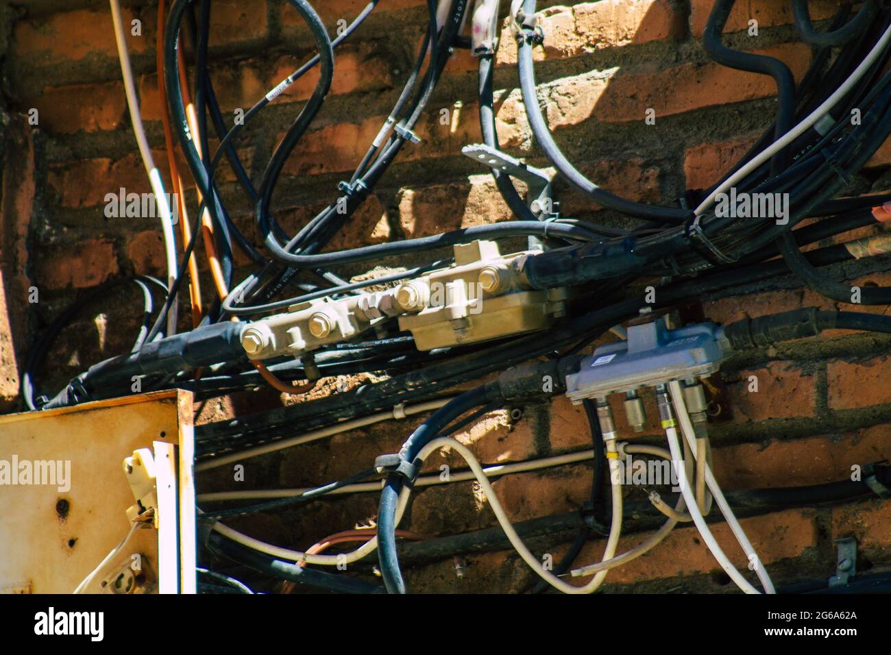 Seville Spain July 03, 2021 Electric cables on the facade of a building ...