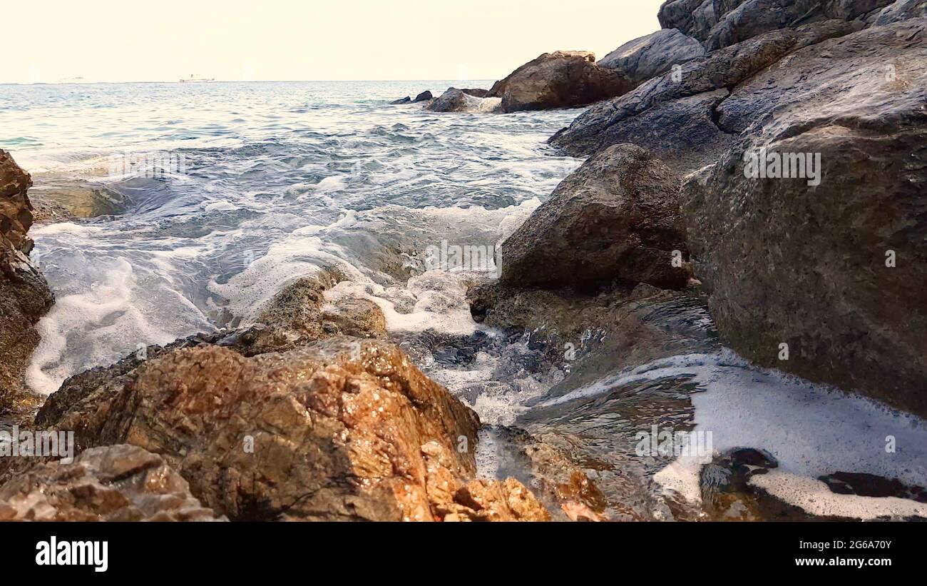 Close up of small waves splashing on the rock Stock Photo - Alamy