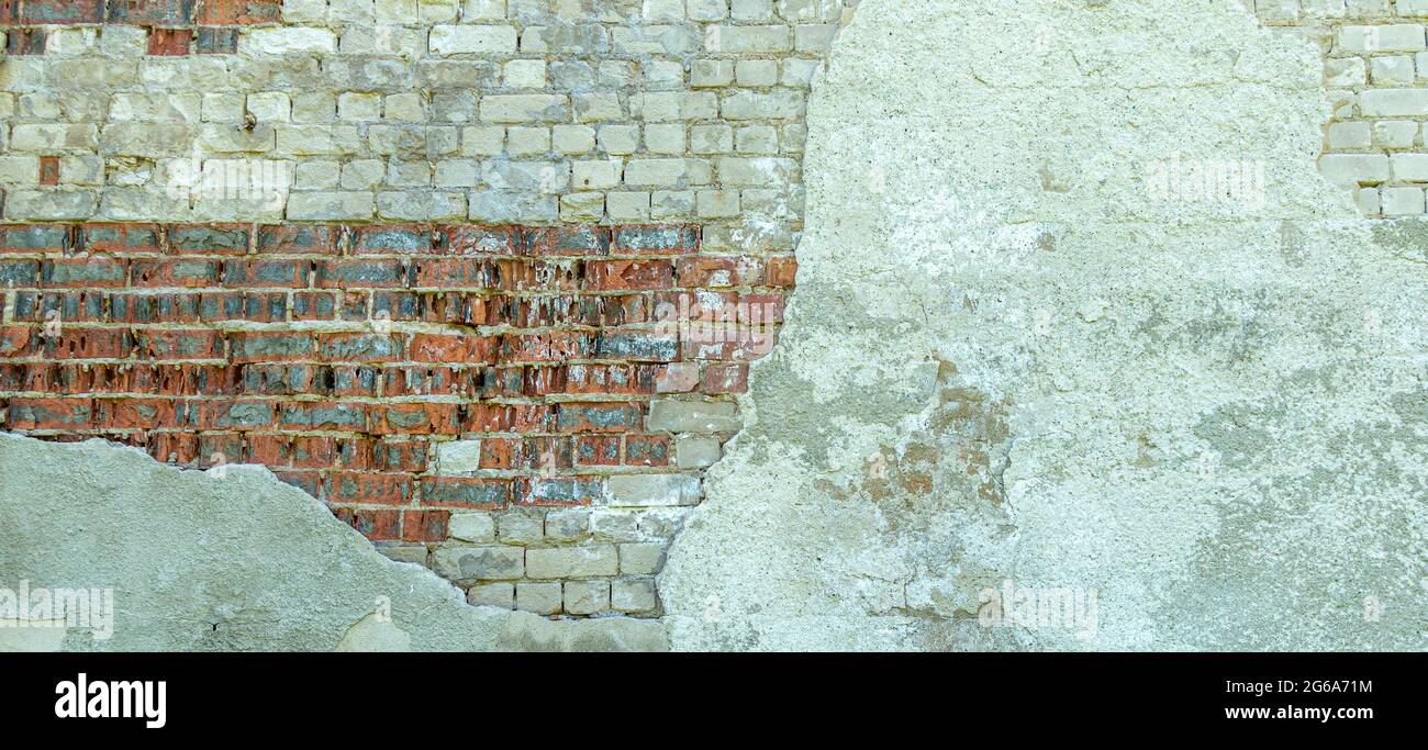 Beige plastered old brickwall with chipped stucco pieces. Grunge red ...
